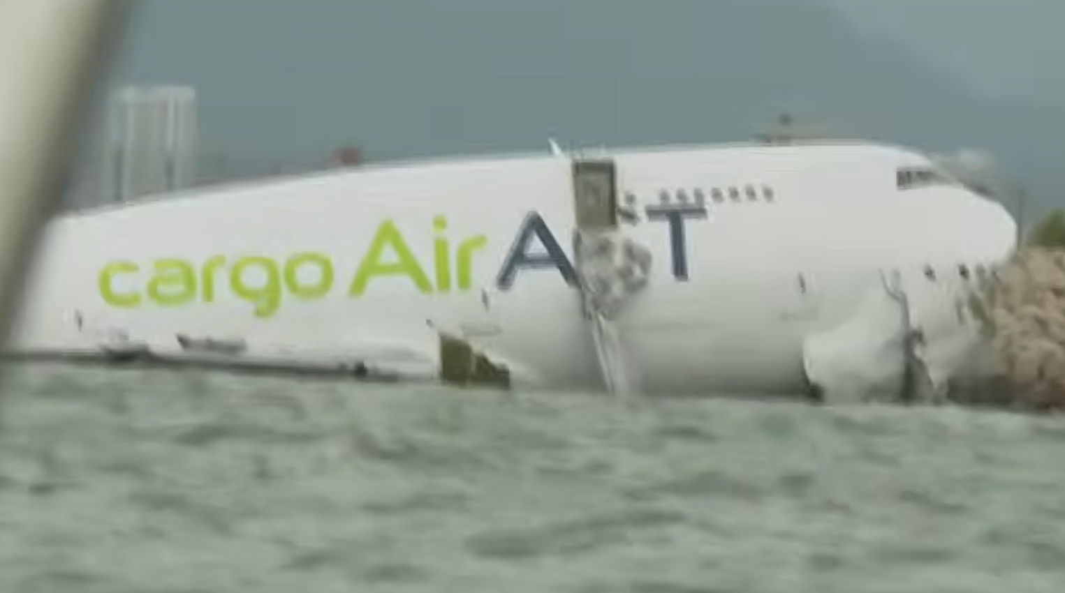 Two die as cargo plane skids off Hong Kong runway into sea ...